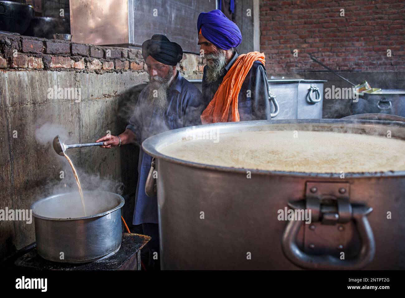 Making chai. Volunteers cooking for the pilgrims who visit the Golden ...