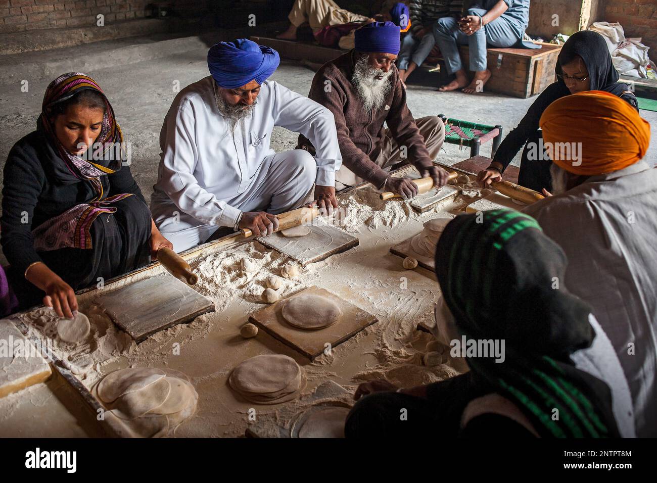 Making chapatis. Volunteers cooking for the pilgrims who visit the ...