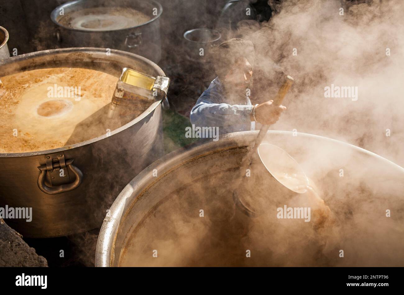 Maiking chai. Volunteer cooking for the pilgrims who visit the Golden ...