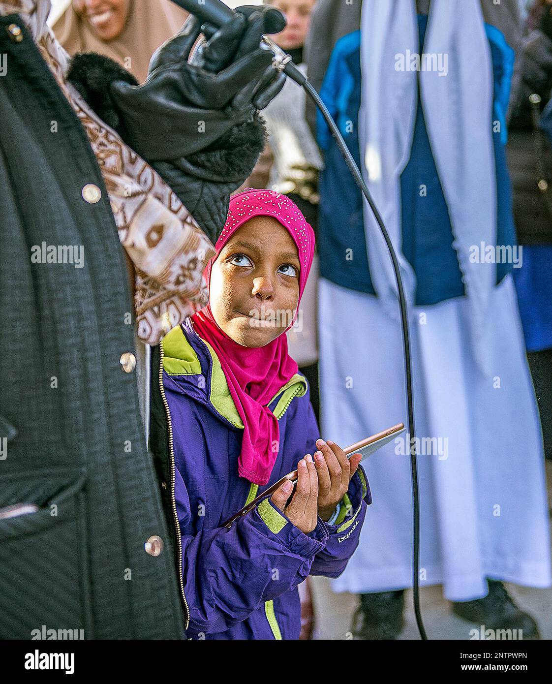 Amina Bashir, 8-years-old, looks up as organizer Fatuma Hussein ...