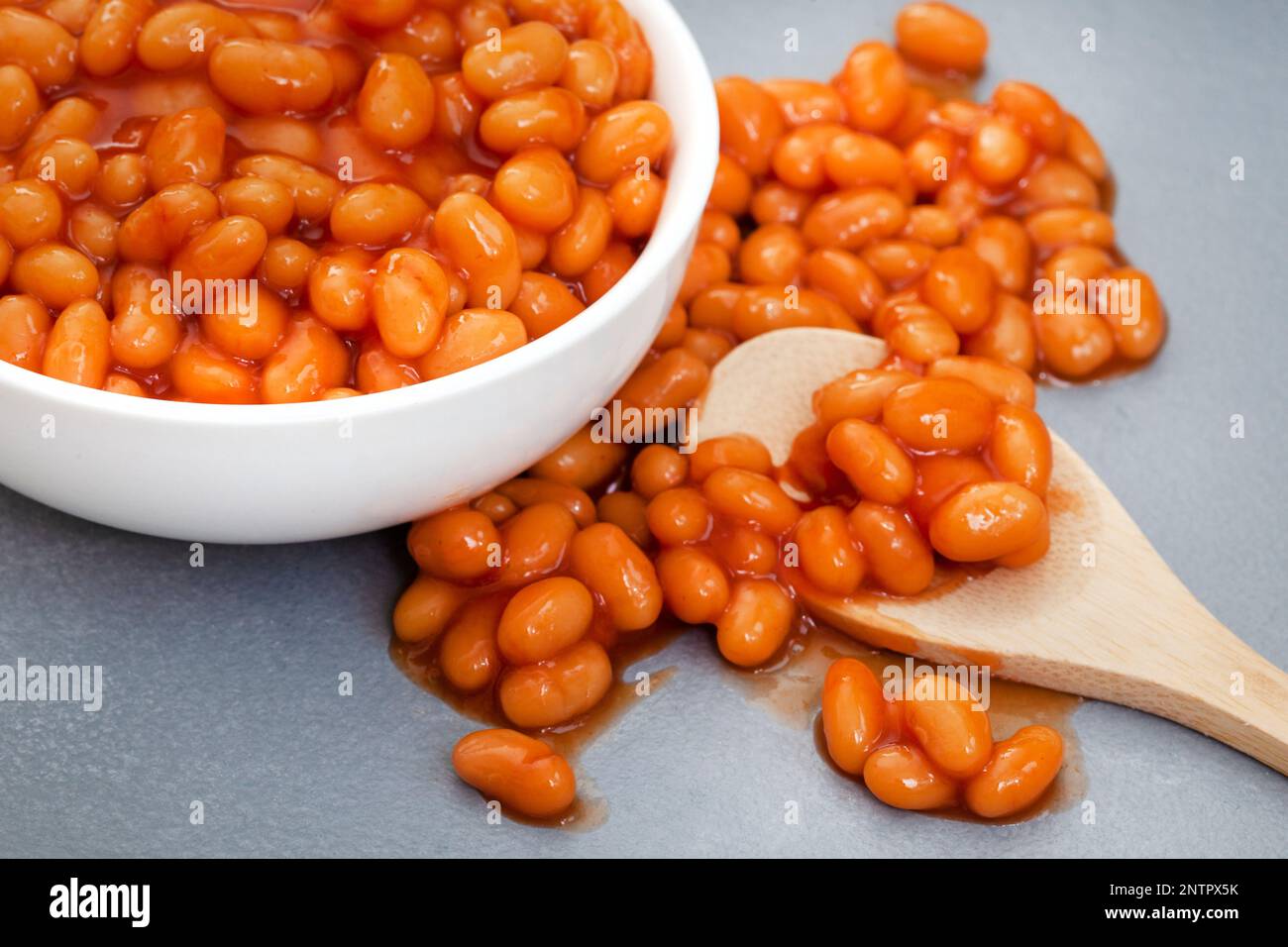 Baked beans from a can on grey surface Stock Photo - Alamy