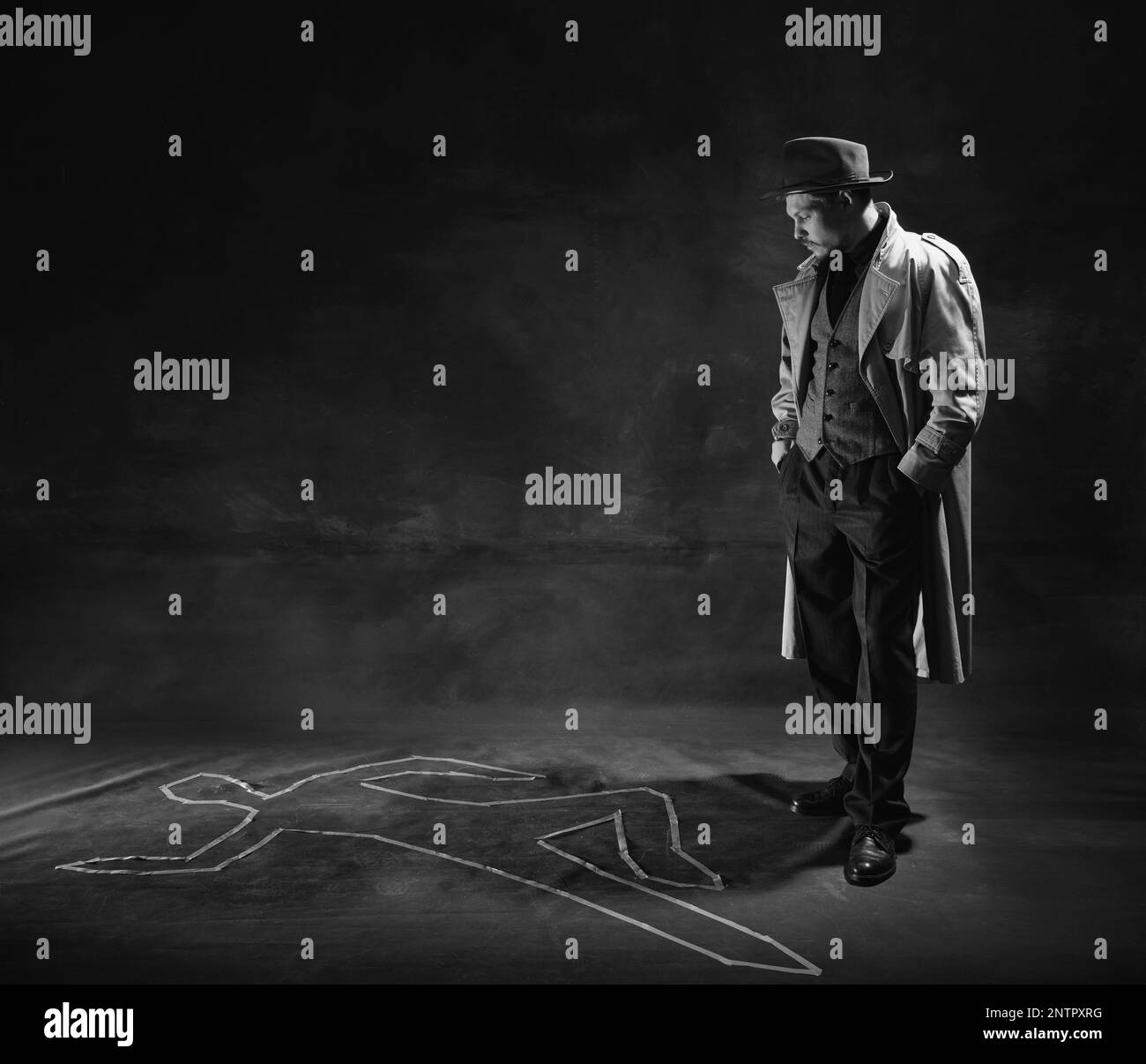 Black and white, noir photography. Man, detective in hat and trench ...