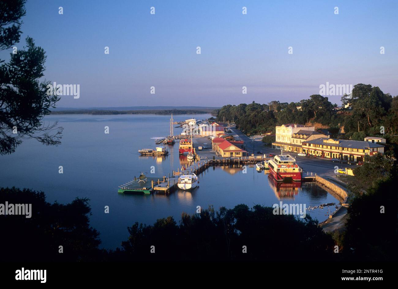Australia, Tasmania, Strahan, early morning light on the village a ...