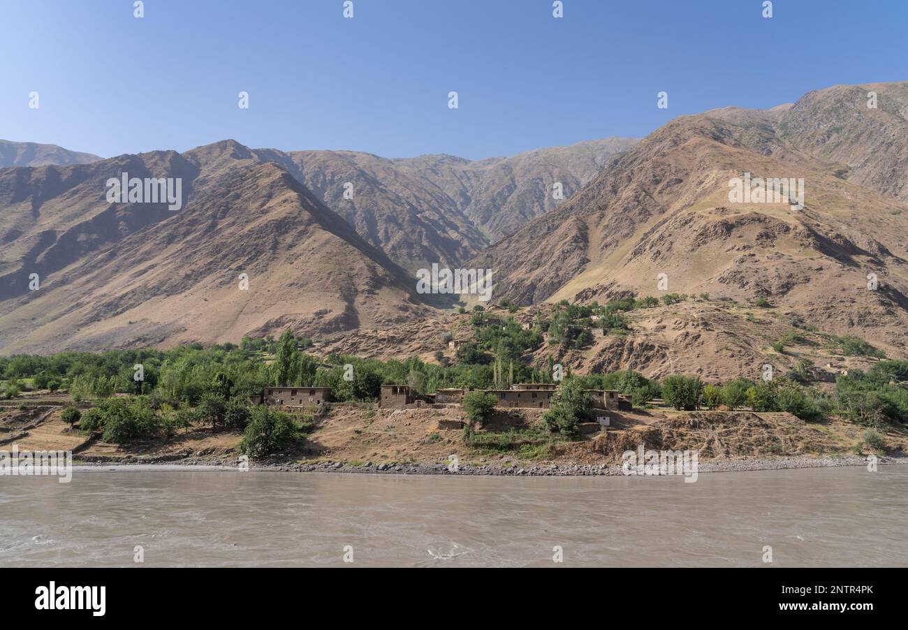 Landscape panorama with traditional mountain village on Afghan side of ...