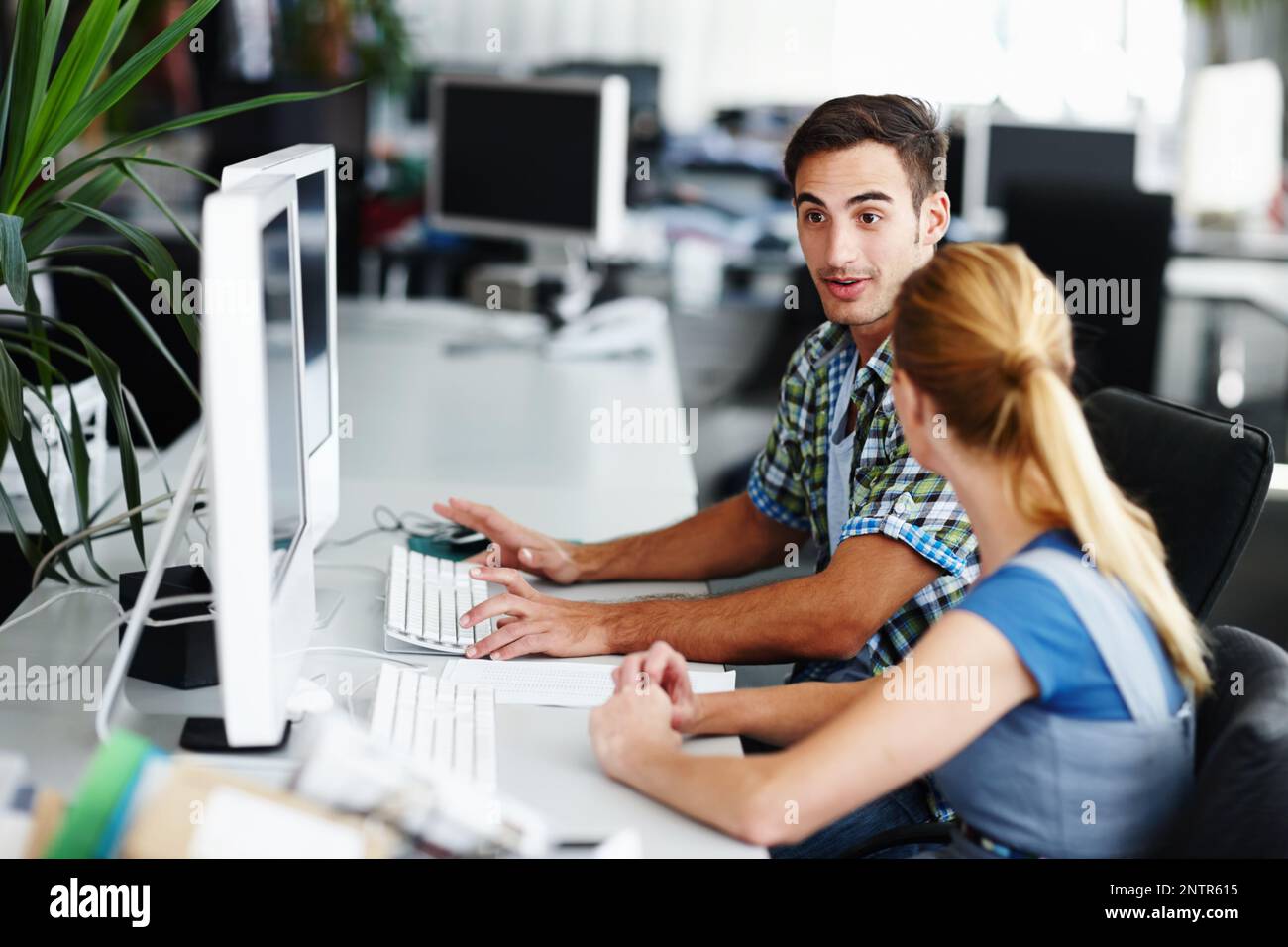 The dynamic duo. Two colleagues working on a computer together Stock ...