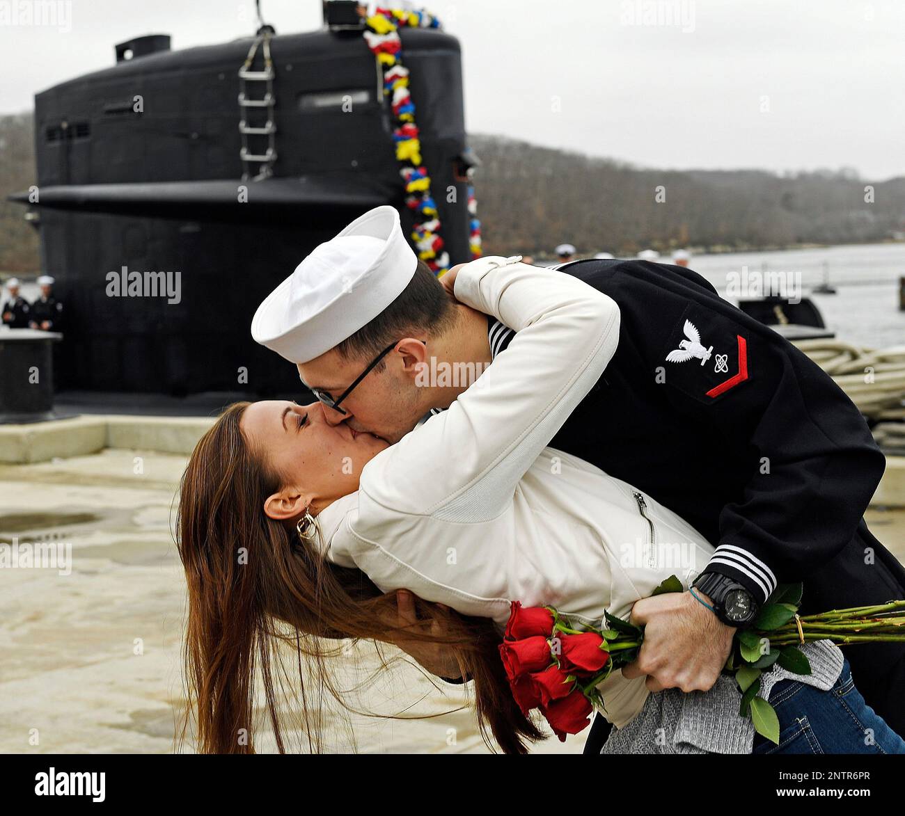 Petty officer third class Collin Miller gives his wife Ashley a dip as ...