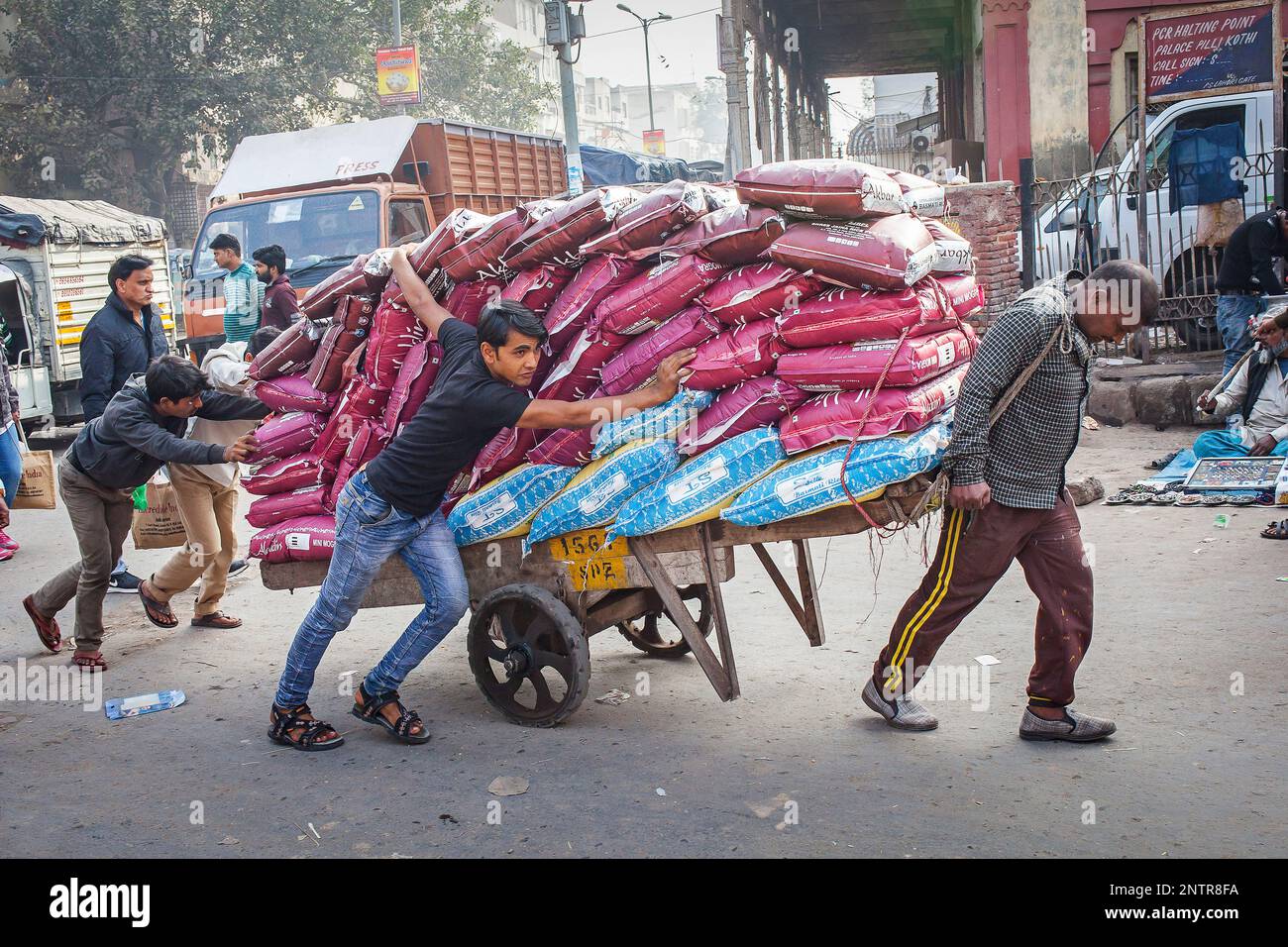 Indian man porter carrying heavy bags hi-res stock photography and ...