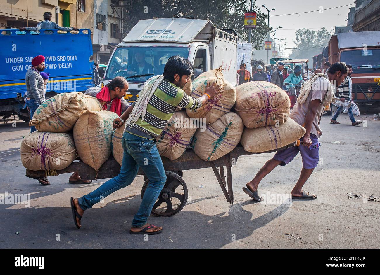 Indian porter man carrying heavy bags hi-res stock photography and ...
