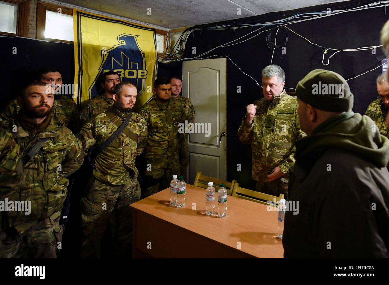 Ukrainian President Petro Poroshenko, second right, speaks to officers ...