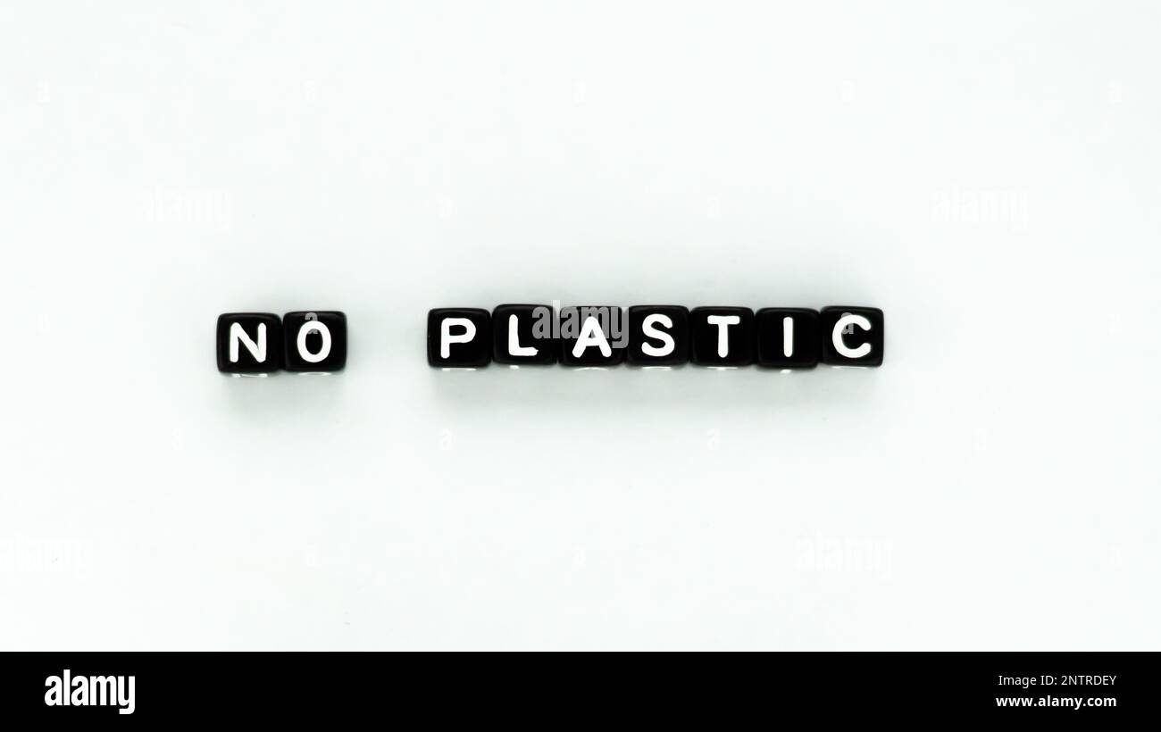 No plastic words in black block letter beads on white background. Save ...