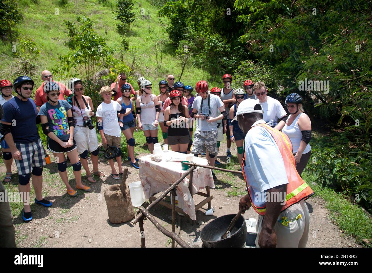 Mountain bikers stop to watch traditional roasting method of coffee ...