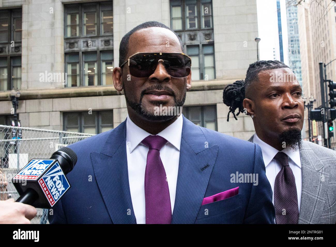R. Kelly and his publicist Darryll Johnson, right, leave The Daley ...