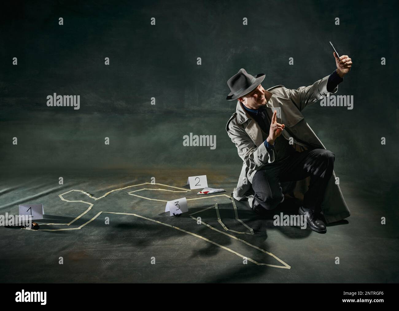 Funny portrait of man, detective in trench coat taking selfie in front ...