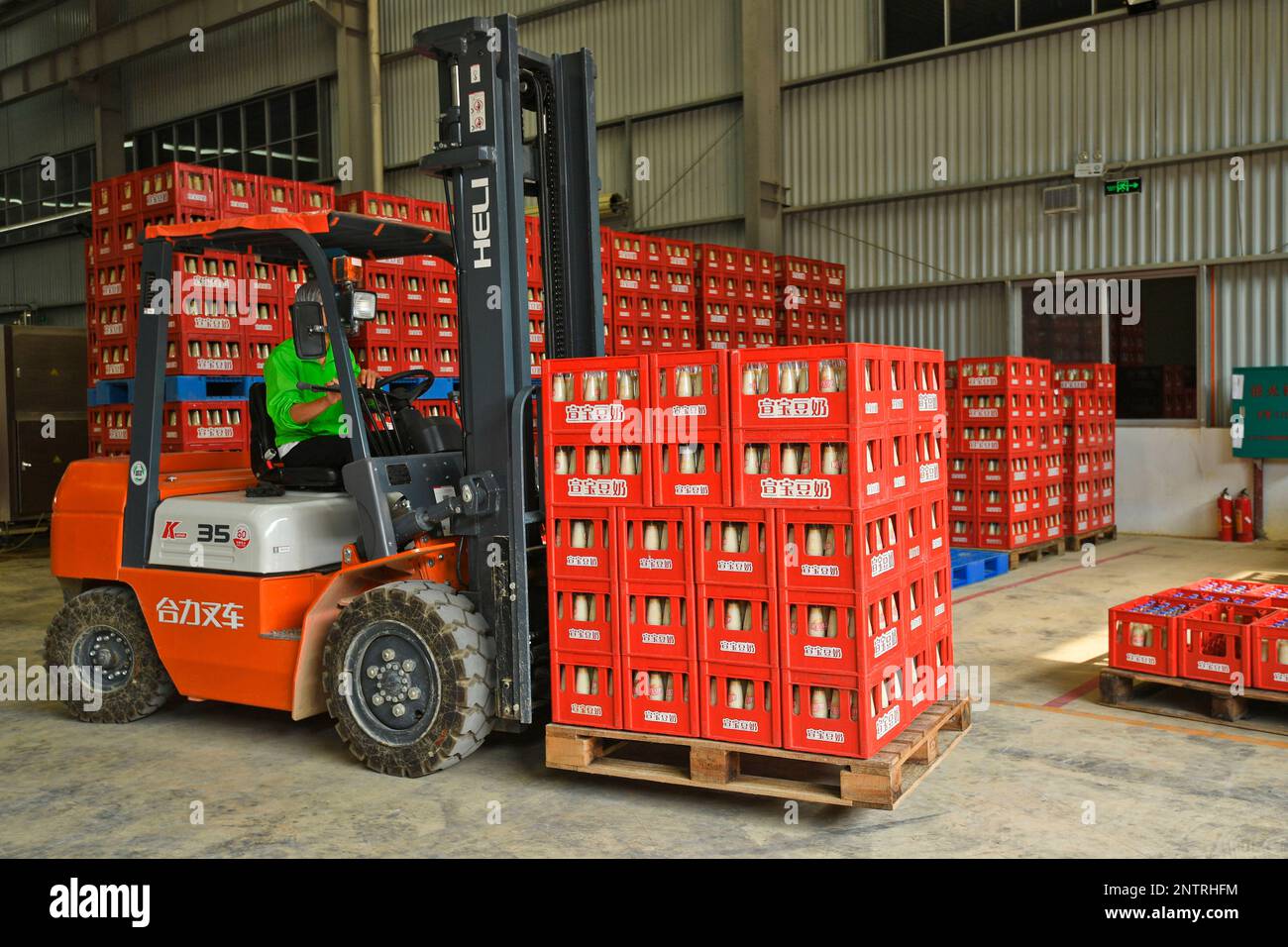 A staff works at a soy milk factory in Nanning in south China's Guangxi ...