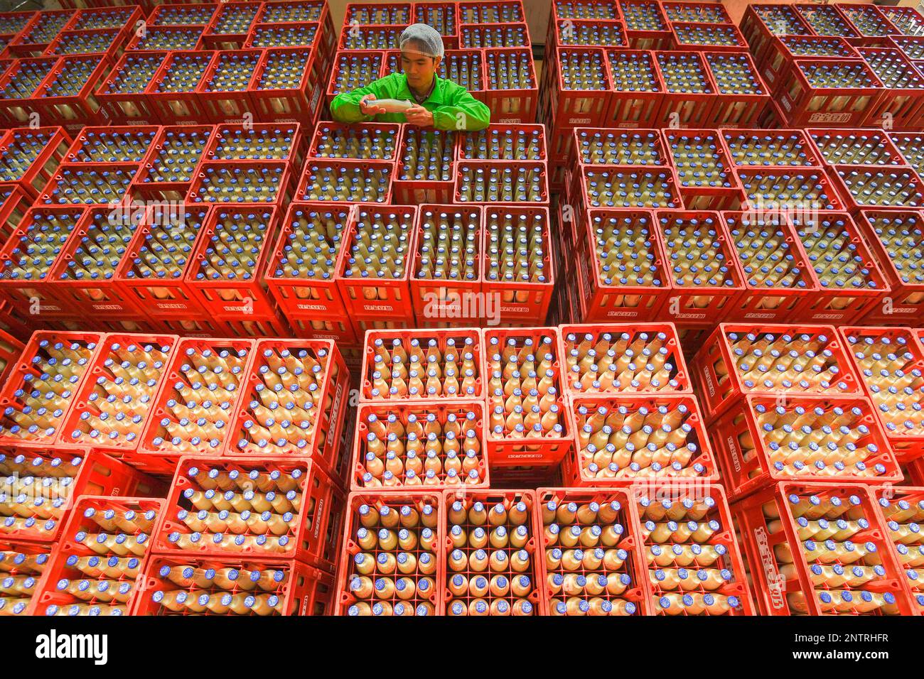 A staff works at a soy milk factory in Nanning in south China's Guangxi ...