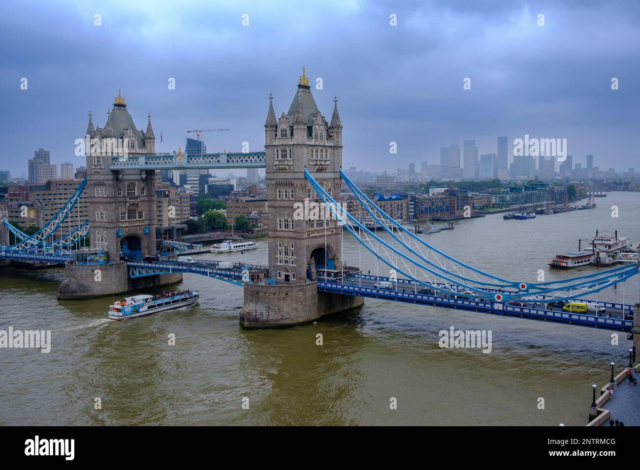 A River Tour boat passes under Tower Bridge, London, viewed from City ...