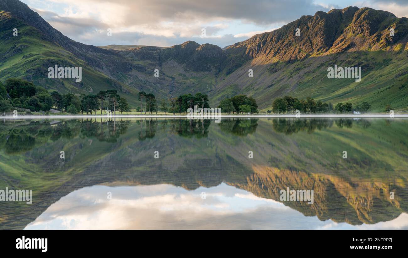 Buttermere lake in the Lake District with the tree line on the edge of ...