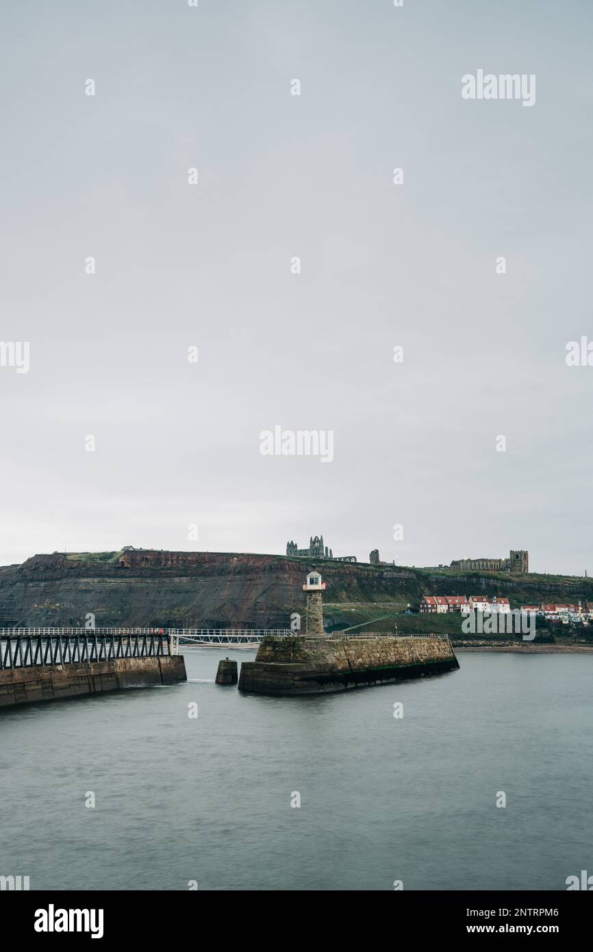 Whitby pier in the harbour and lighthouses to warn the ships and boats ...