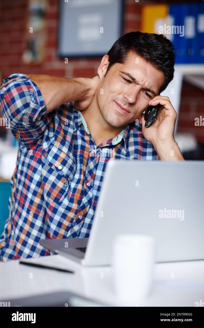 Work is getting to him. A stressed young entrepreneur rubbing his neck ...