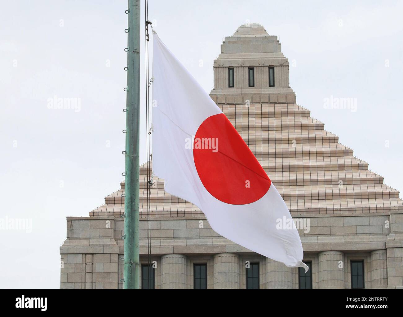 A half-mast flag is hoisted at the National Diet building to ...