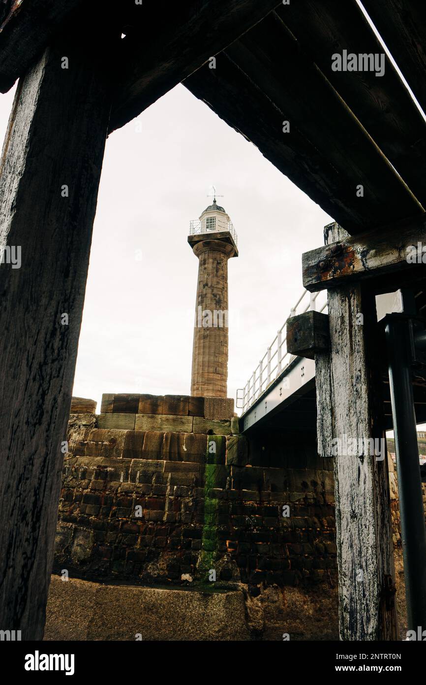 Whitby pier in the harbour and lighthouses to warn the ships and boats ...
