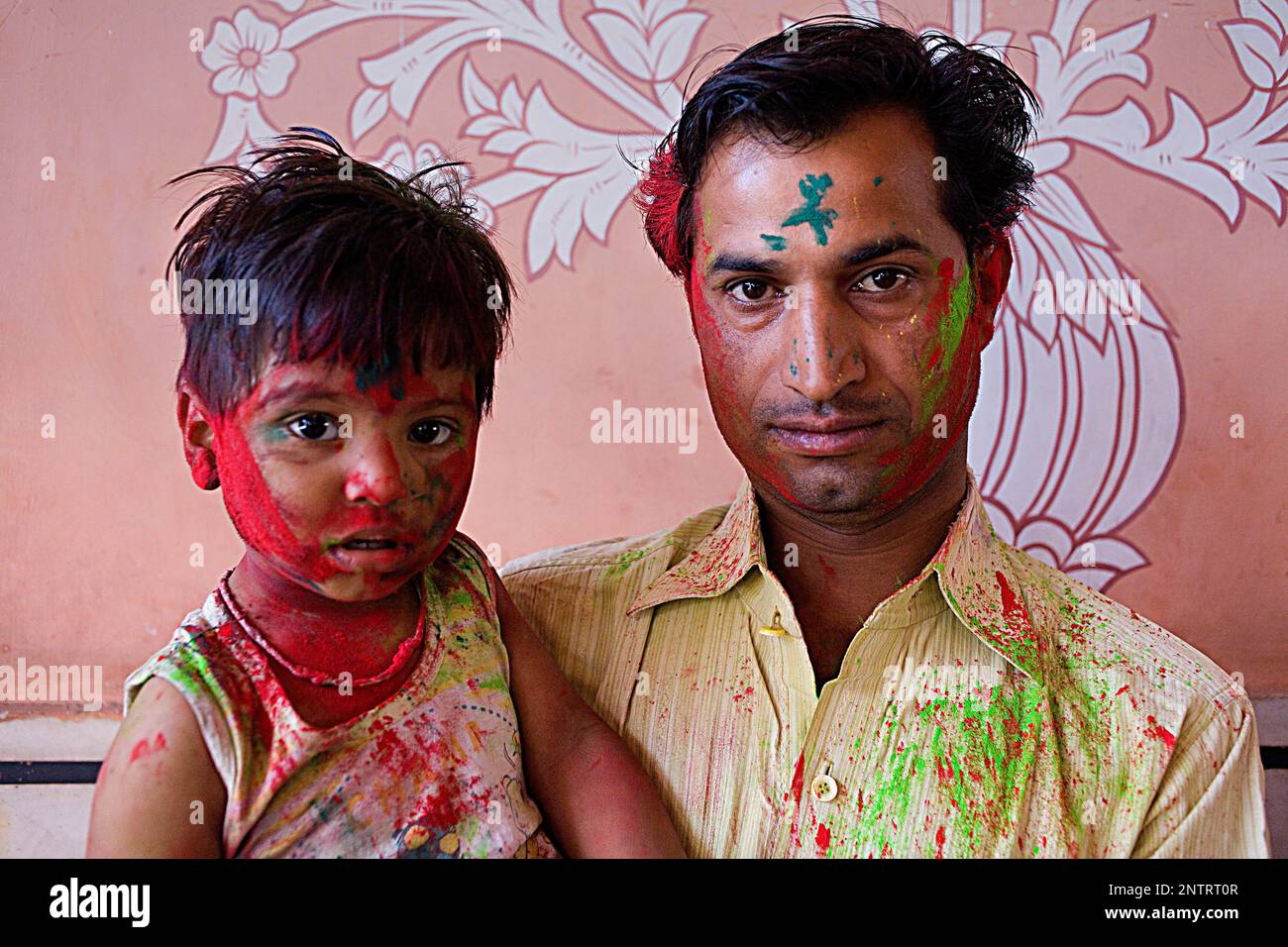 Father and son celebrating the Holi spring festival to celebrate the ...