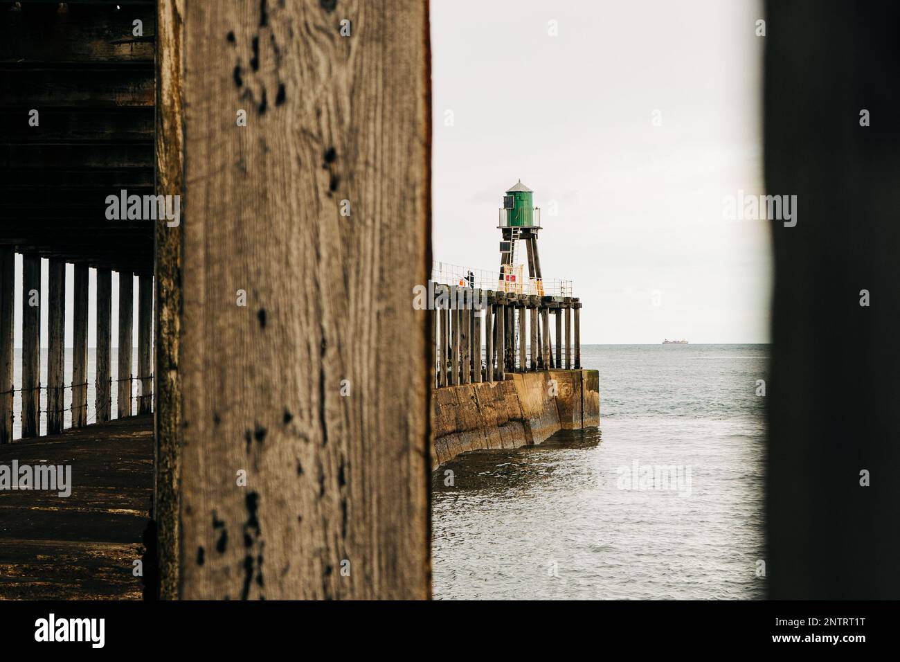 Whitby pier in the harbour and lighthouses to warn the ships and boats ...