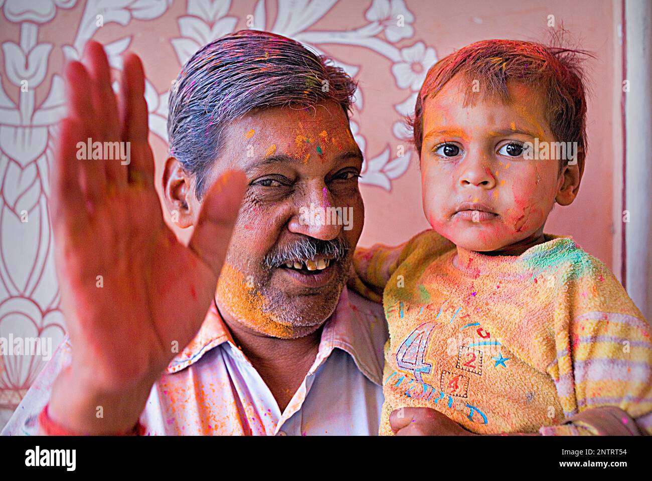 Father and son celebrating the Holi spring festival to celebrate the ...