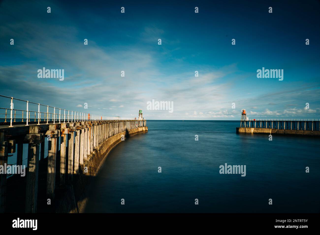 Whitby pier in the harbour and lighthouses to warn the ships and boats ...