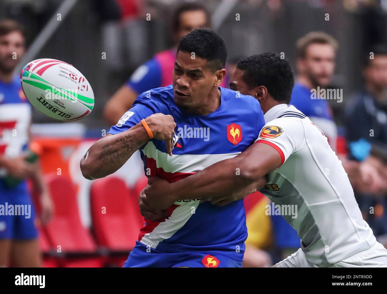 France's Remi Siega, left, is tackled by USA's Marcus Tupuola, right ...