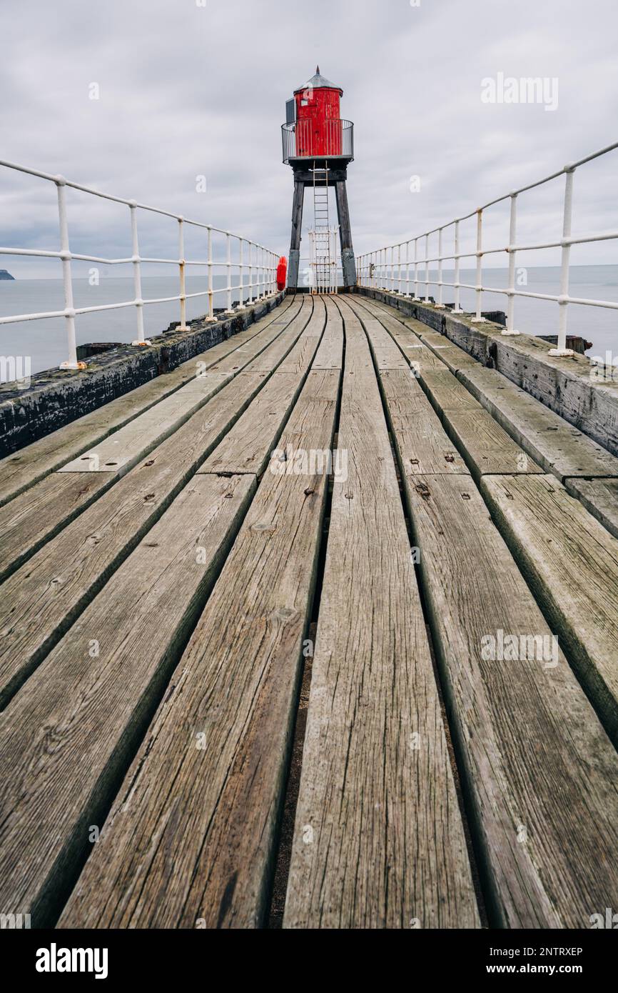 Whitby pier in the harbour and lighthouses to warn the ships and boats ...