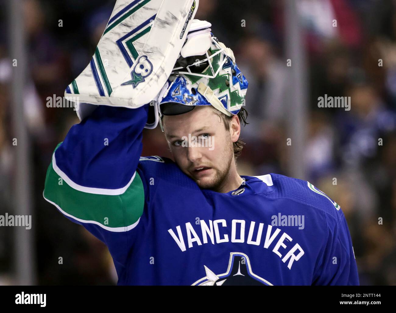 Vancouver Canucks goaltender Thatcher Demko (35) adjusts his mask ...