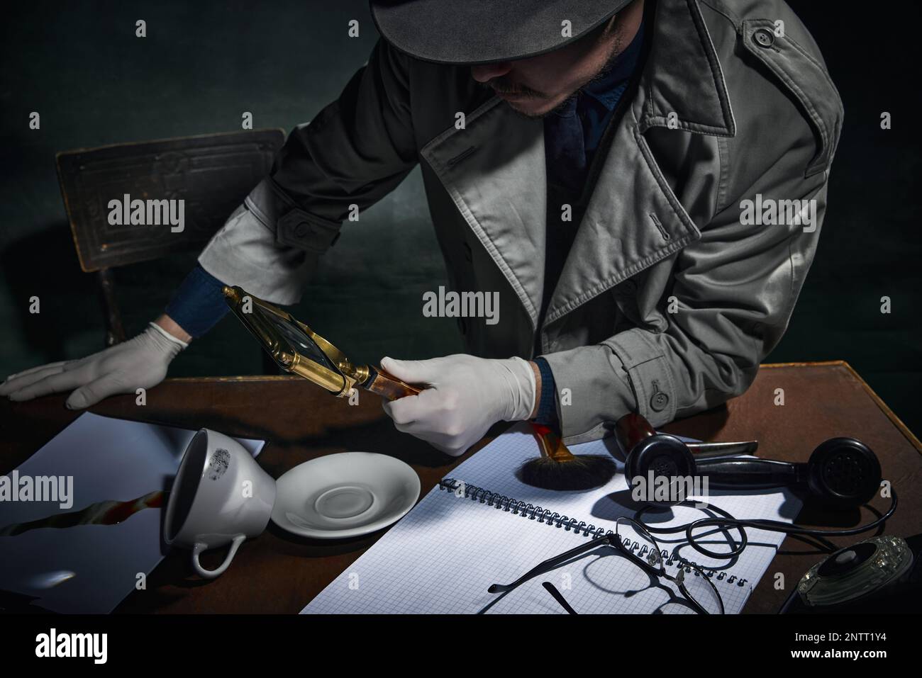 Cropped image of male detective looking in magnifying glass at ...