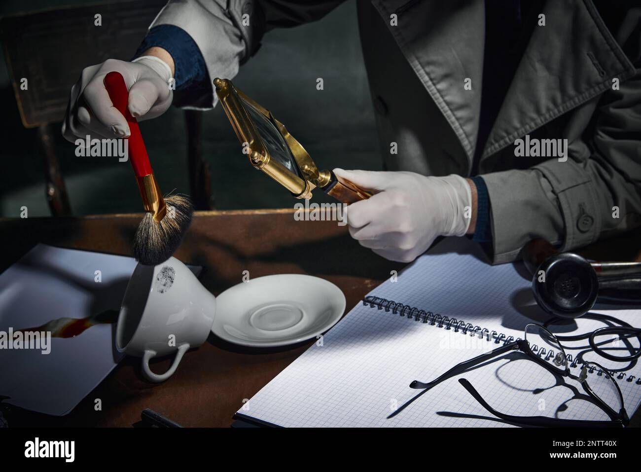 Cropped image of male detective looking in magnifying glass at ...