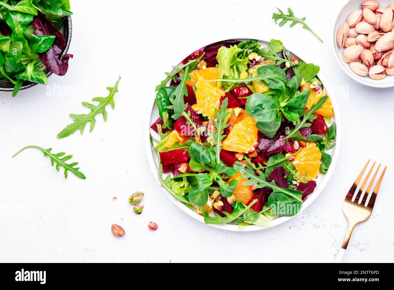 Beet and orange healthy salad with arugula, lamb lettuce, mini chard ...