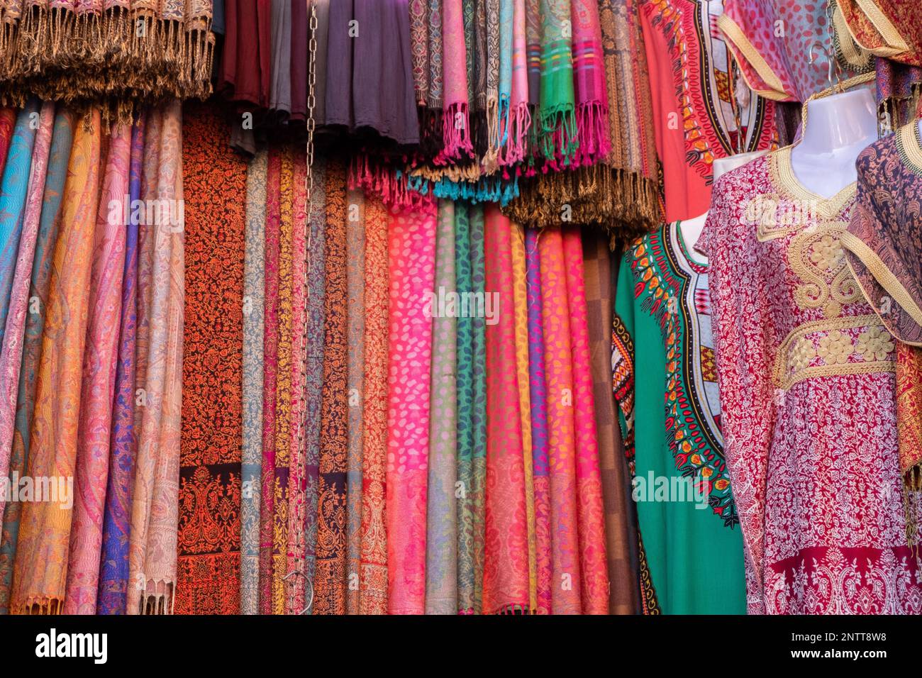 typical moroccan clothes on display in a shop in a souk in marrakech ...