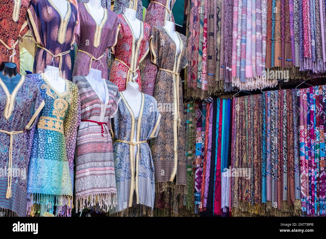 typical moroccan clothes on display in a shop in a souk in marrakech ...
