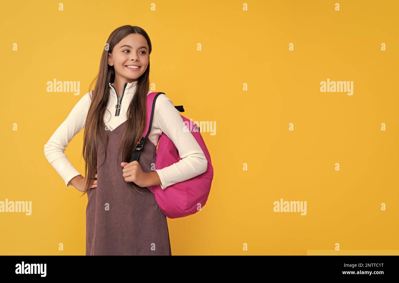 cheerful child with school bag on yellow background Stock Photo - Alamy