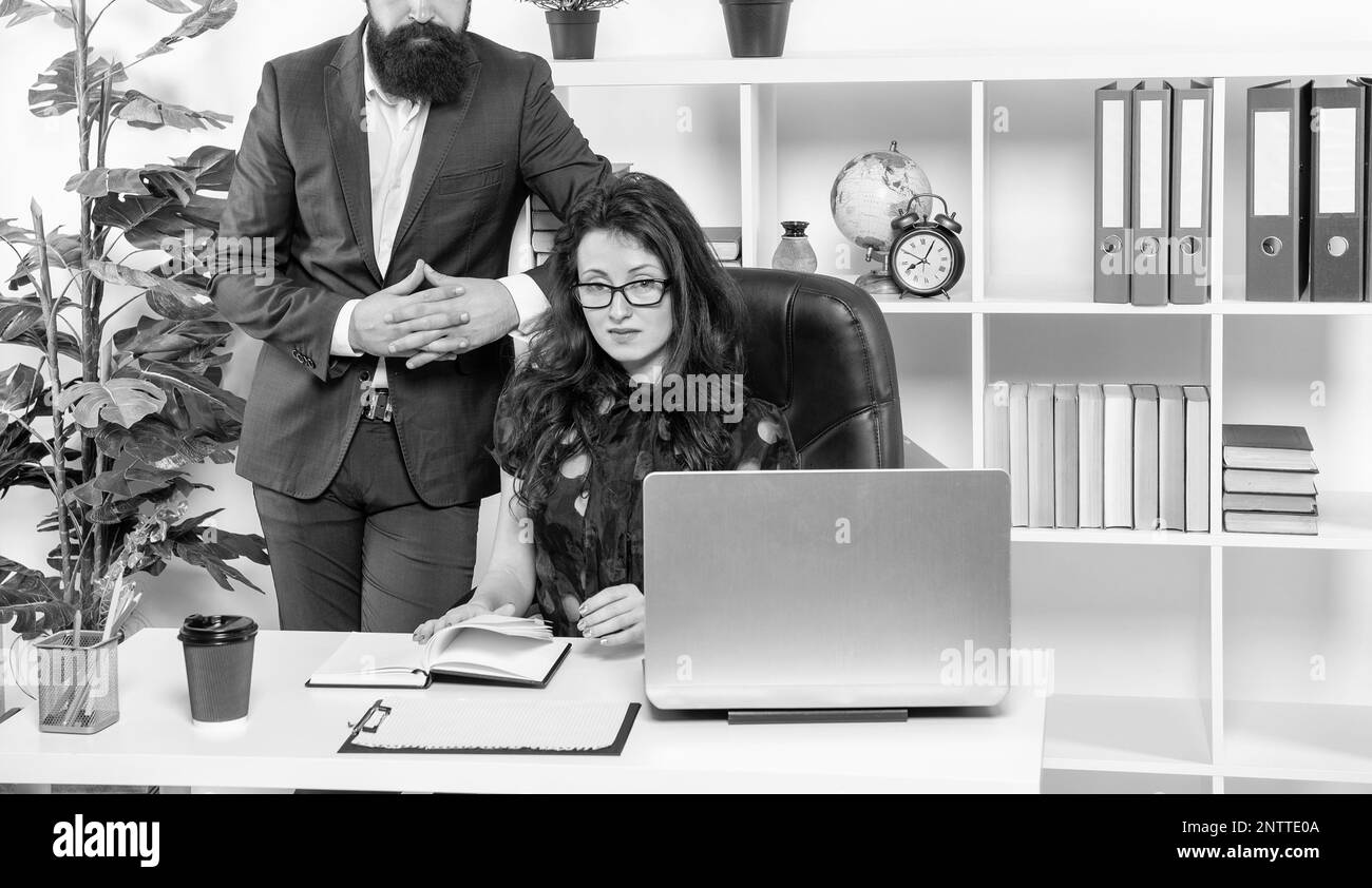 Focusing on the task. Serious woman at work. Man crop view stand over ...