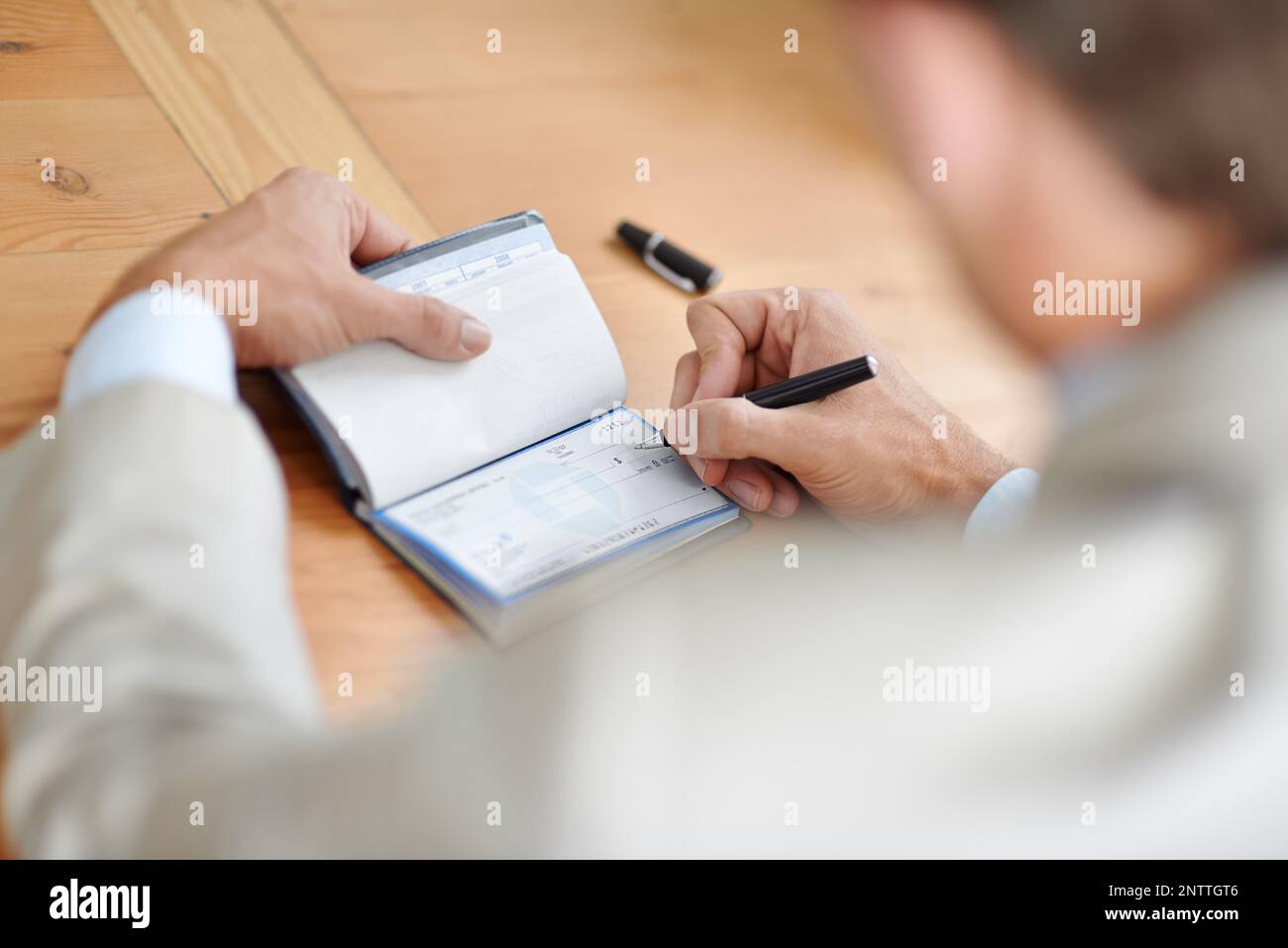 Signing cheques hi-res stock photography and images - Alamy