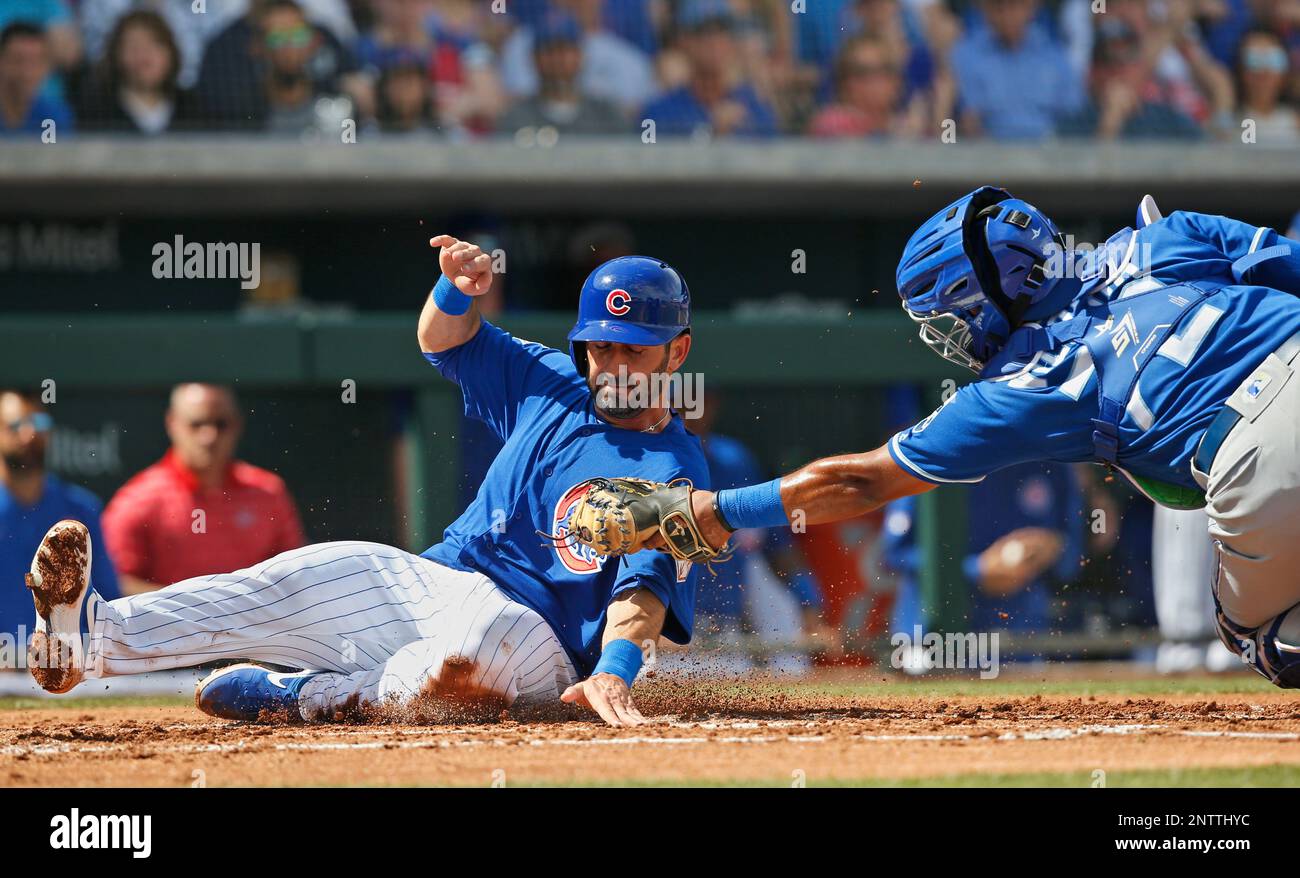 Chicago Cubs' Daniel Descalso, left, slides past the outstretched arm ...
