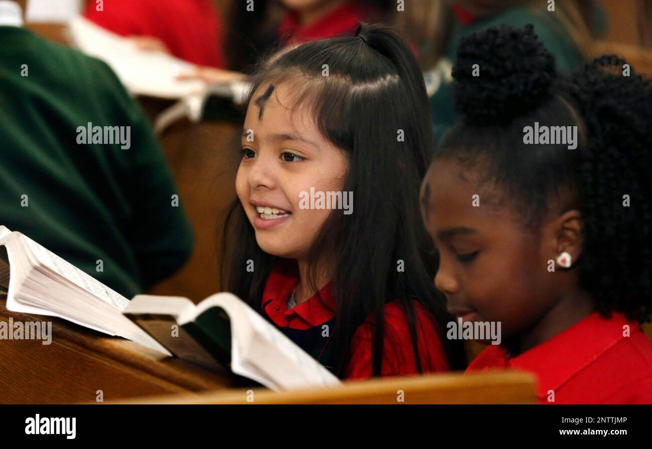 Second grader Jazlyn Ramirez, 7, sings along with third grader Lailah ...