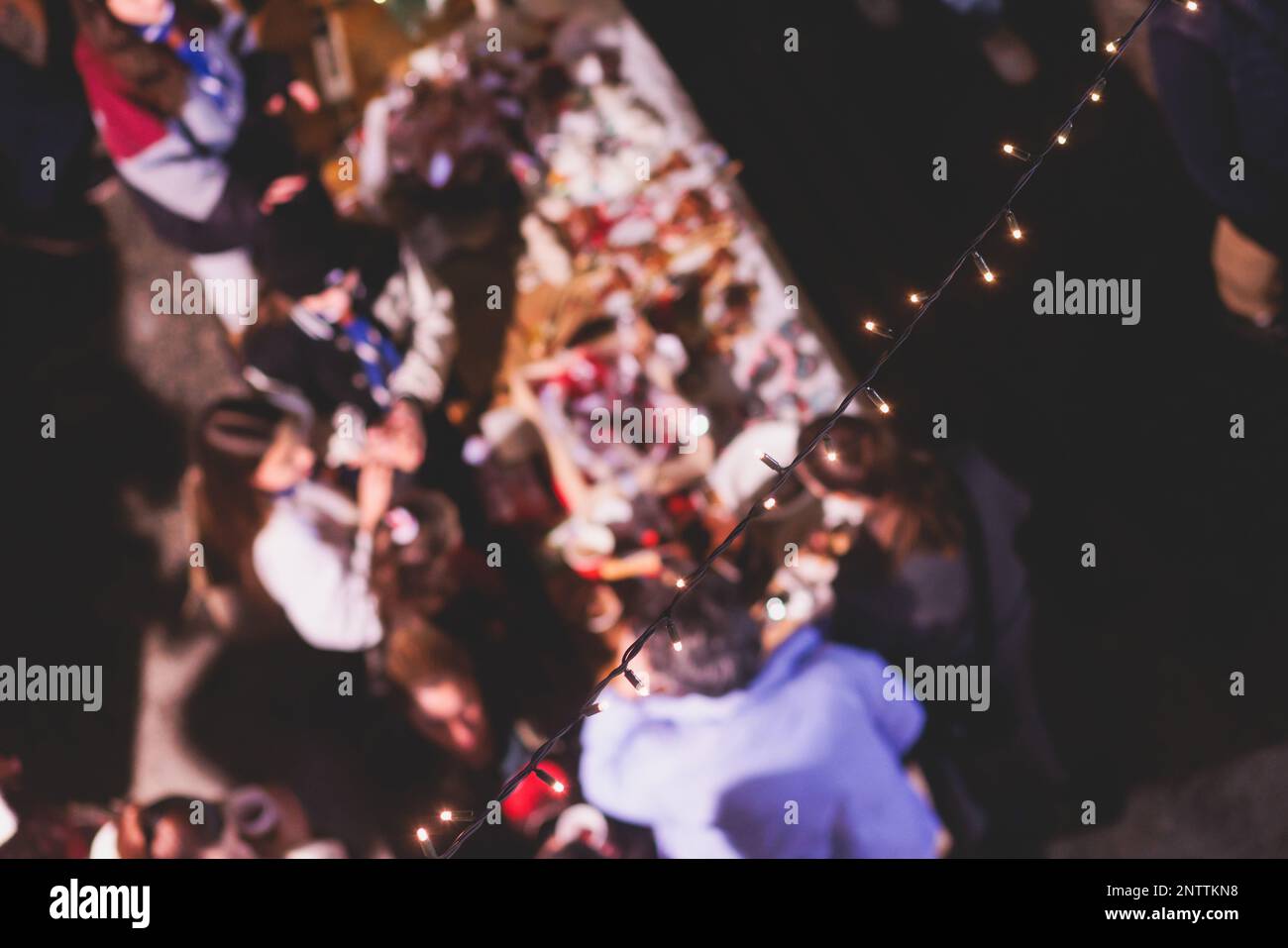 Crowded Christmas market fair with a New Year decorations, balloons ...