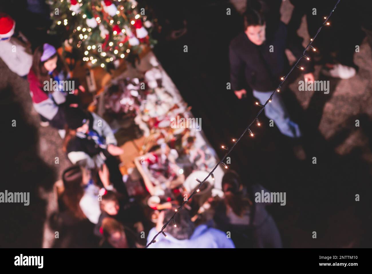 Crowded Christmas market fair with a New Year decorations, balloons ...