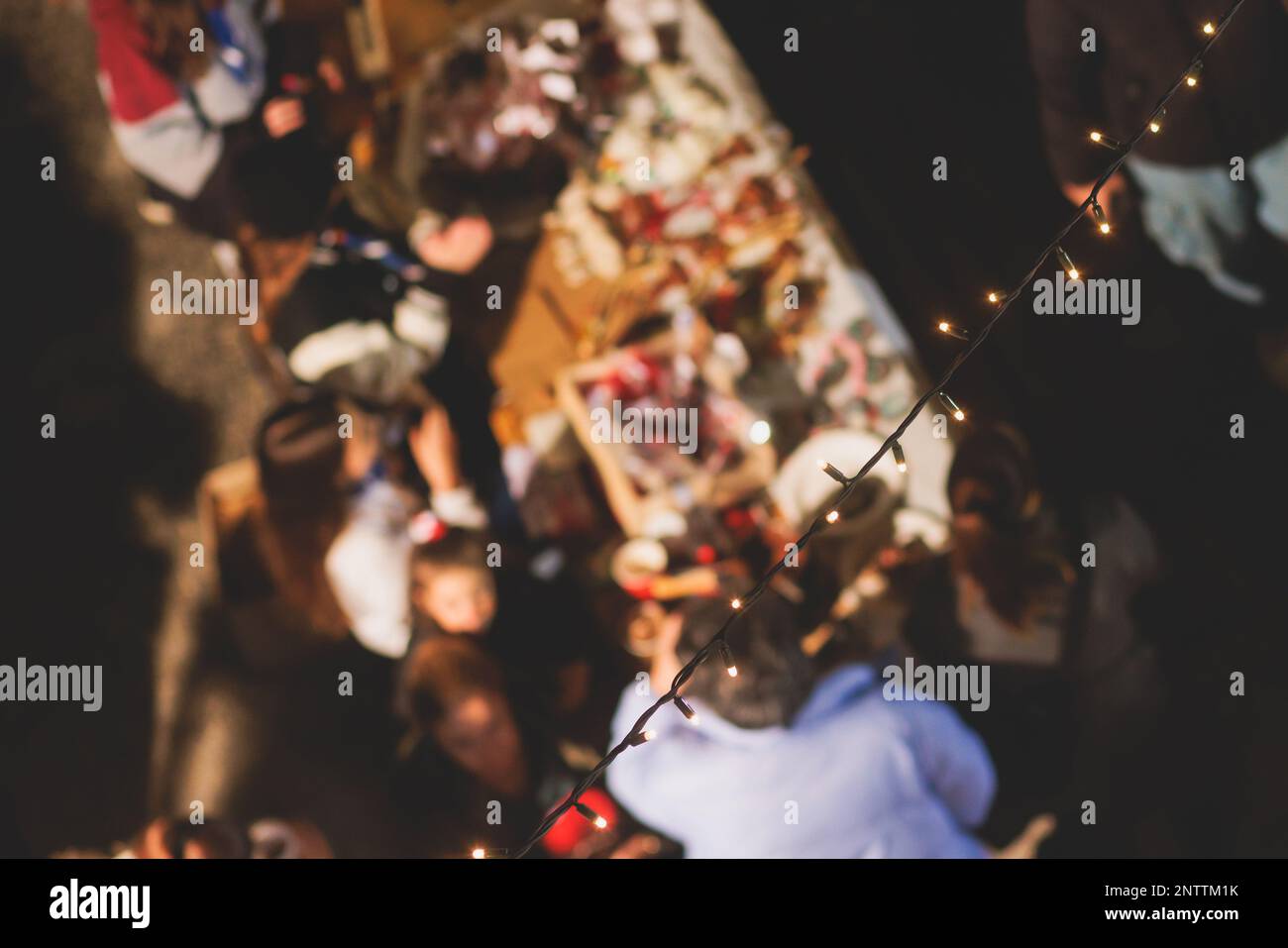 Crowded Christmas market fair with a New Year decorations, balloons ...