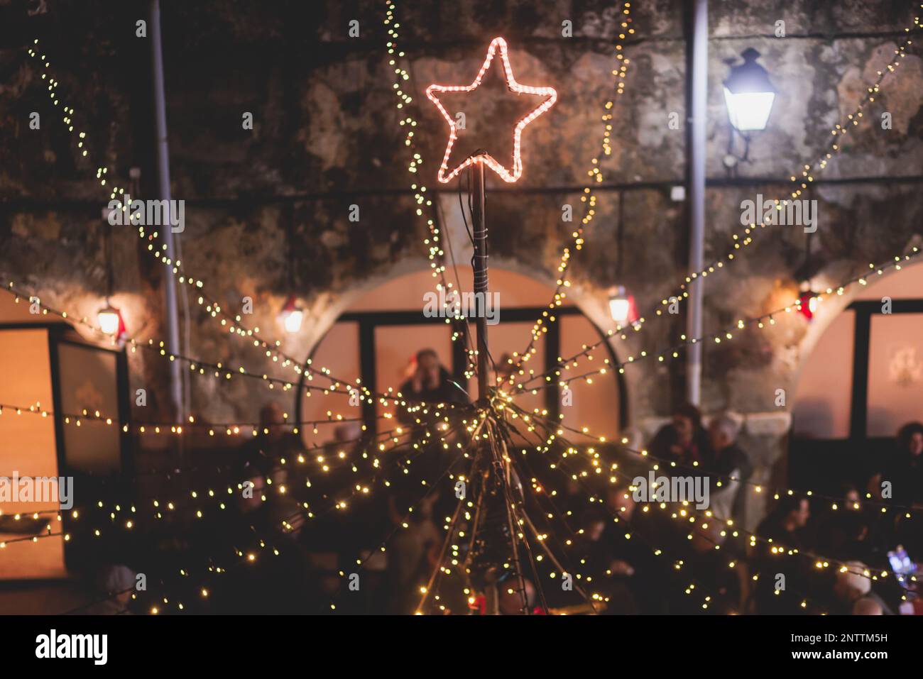 Crowded Christmas market fair with a New Year decorations, balloons ...