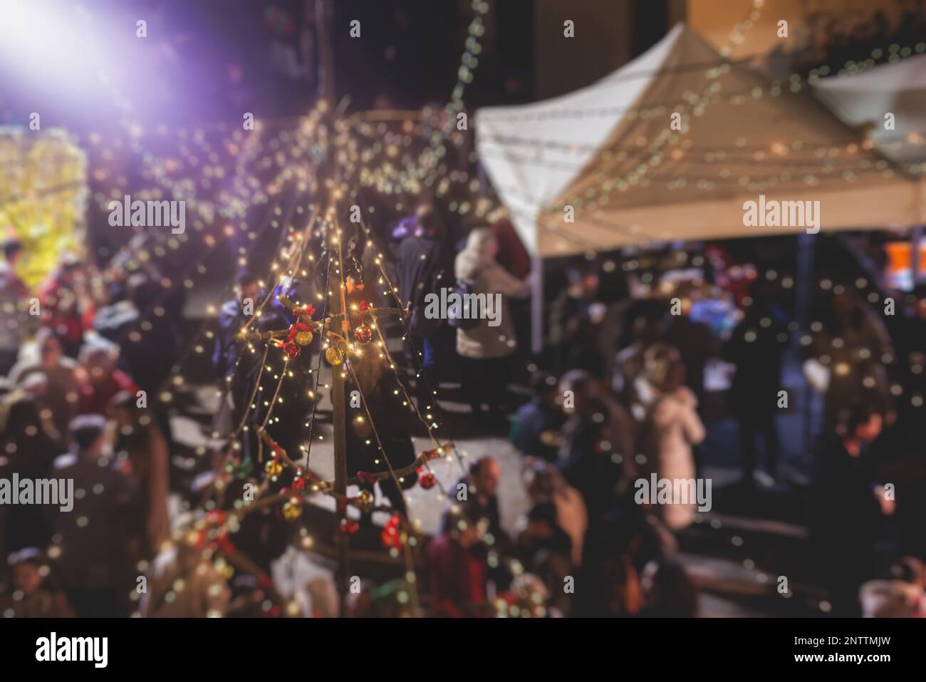 Crowded Christmas market fair with a New Year decorations, balloons ...