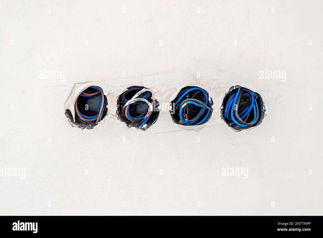 Holes for sockets in the wall in a newly built room Stock Photo - Alamy