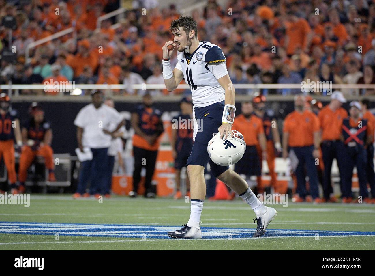 West Virginia quarterback Jack Allison (11) heads to the sideline ...