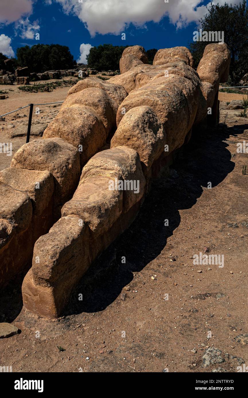 Atlas rests in the sun amid the ruins of an Ancient Greek temple ...